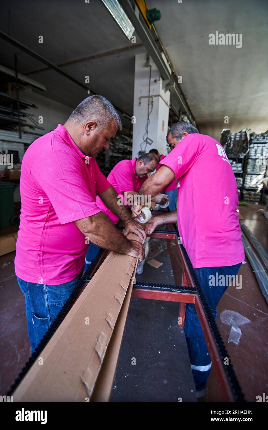 Workers packing cardboard box in warehouse for shipment. an operator ...