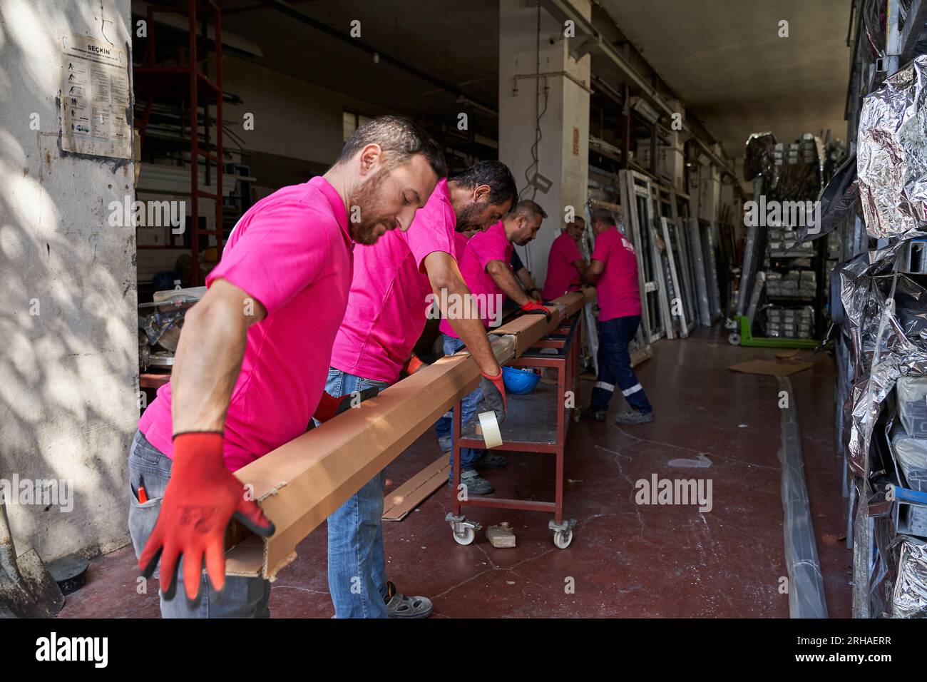 Workers packing cardboard box in warehouse for shipment. an operator ...