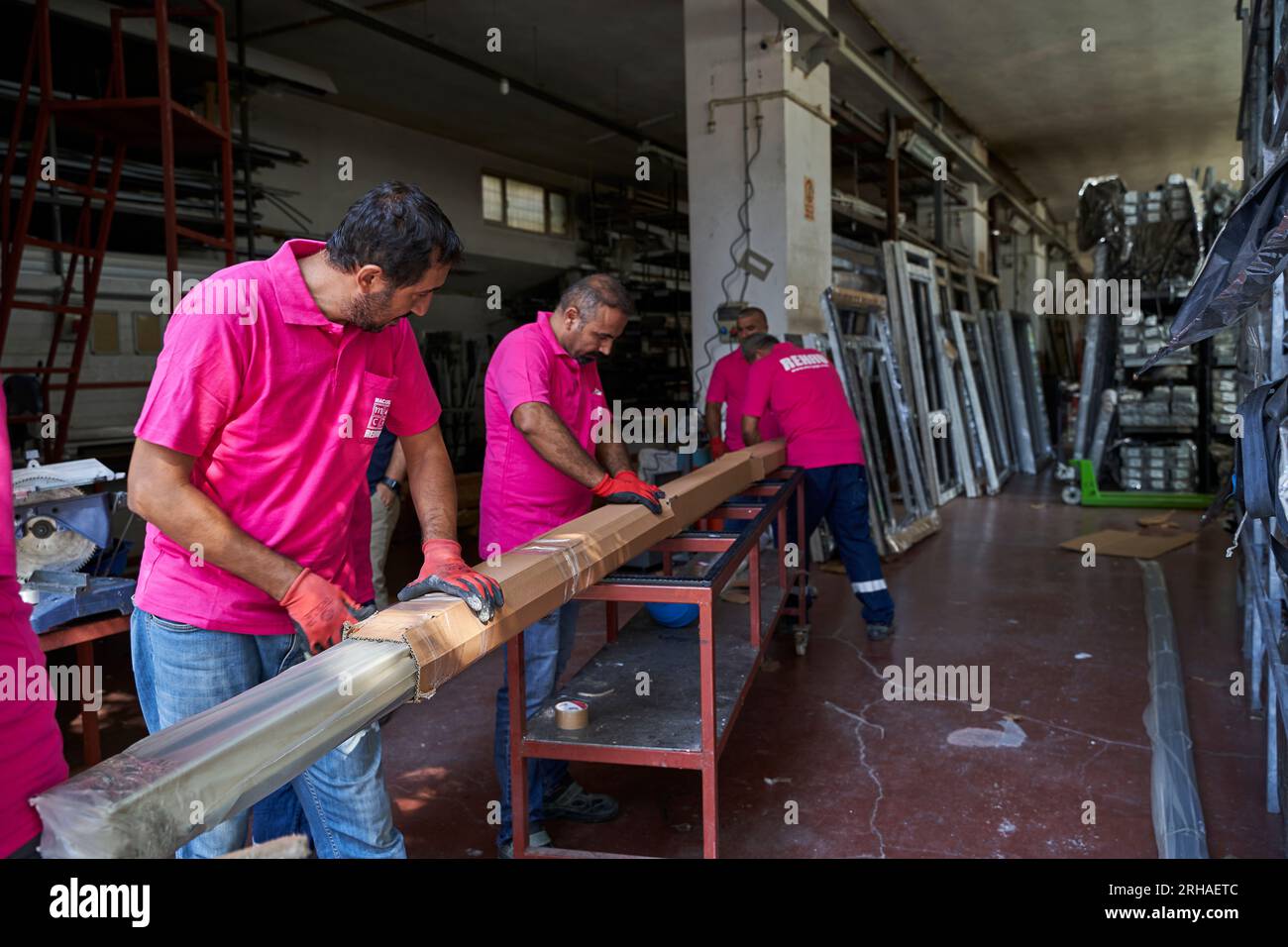 Workers packing cardboard box in warehouse for shipment. an operator ...