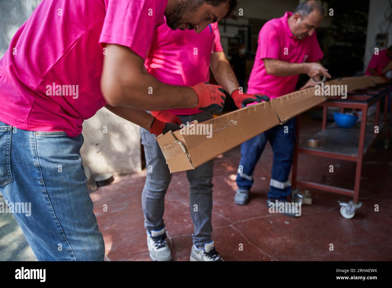 Workers packing cardboard box in warehouse for shipment. an operator ...