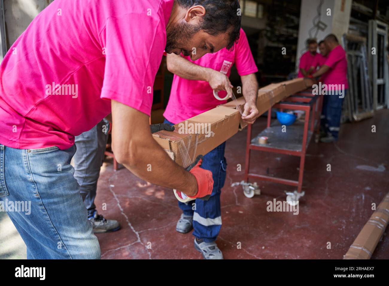 Workers packing cardboard box in warehouse for shipment. an operator ...