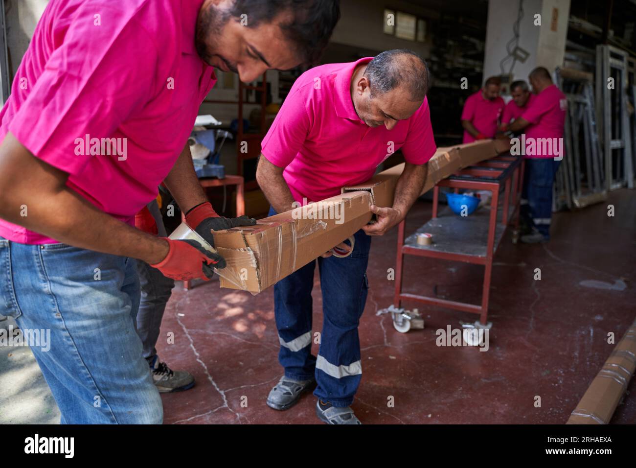 Workers packing cardboard box in warehouse for shipment. an operator ...