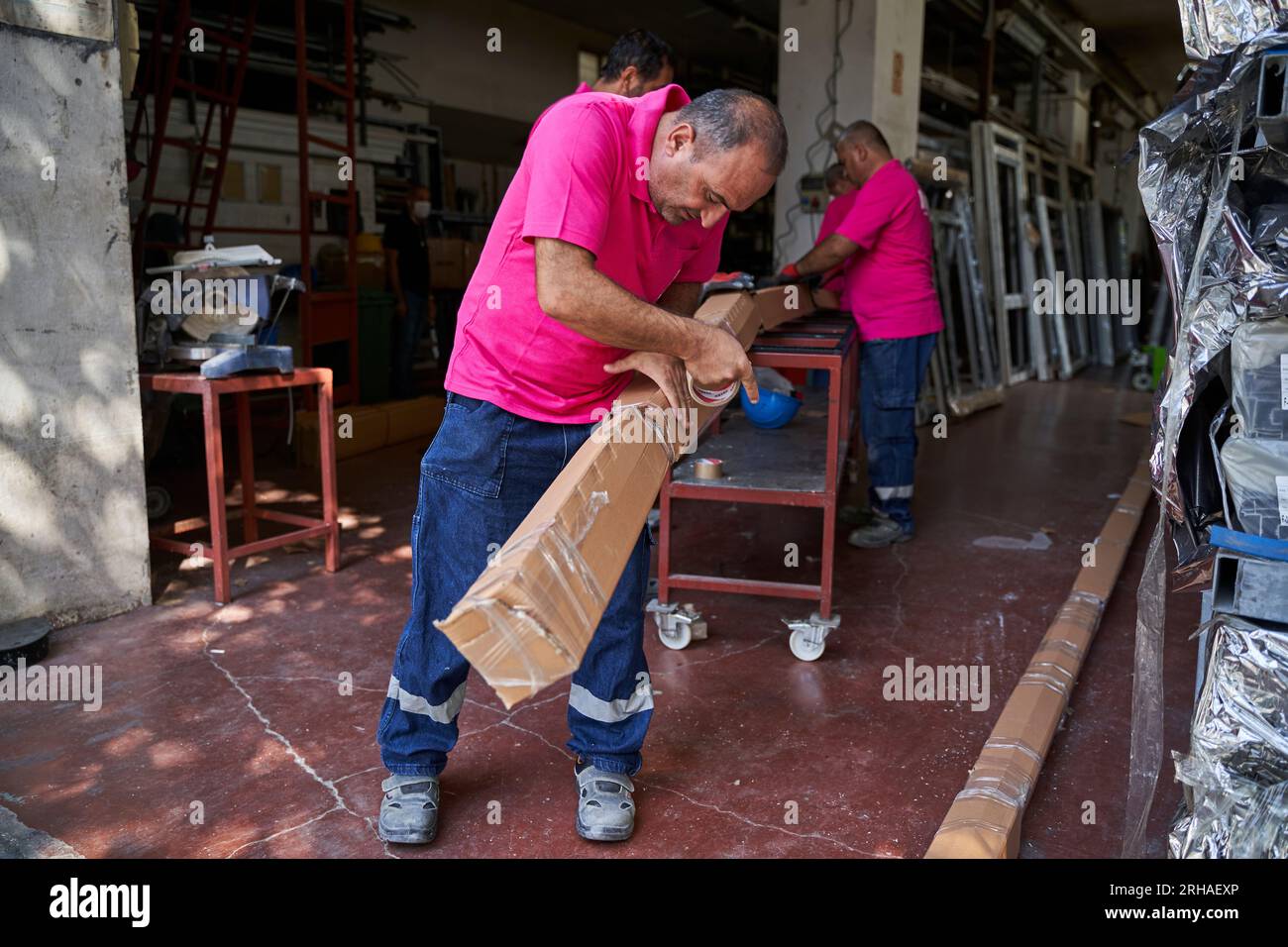 Workers packing cardboard box in warehouse for shipment. an operator ...