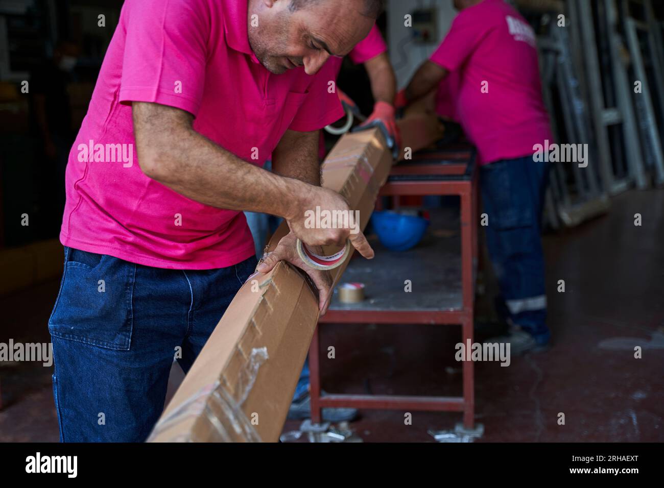 Workers packing cardboard box in warehouse for shipment. an operator ...