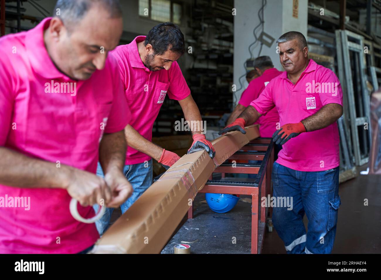 Workers packing cardboard box in warehouse for shipment. an operator ...