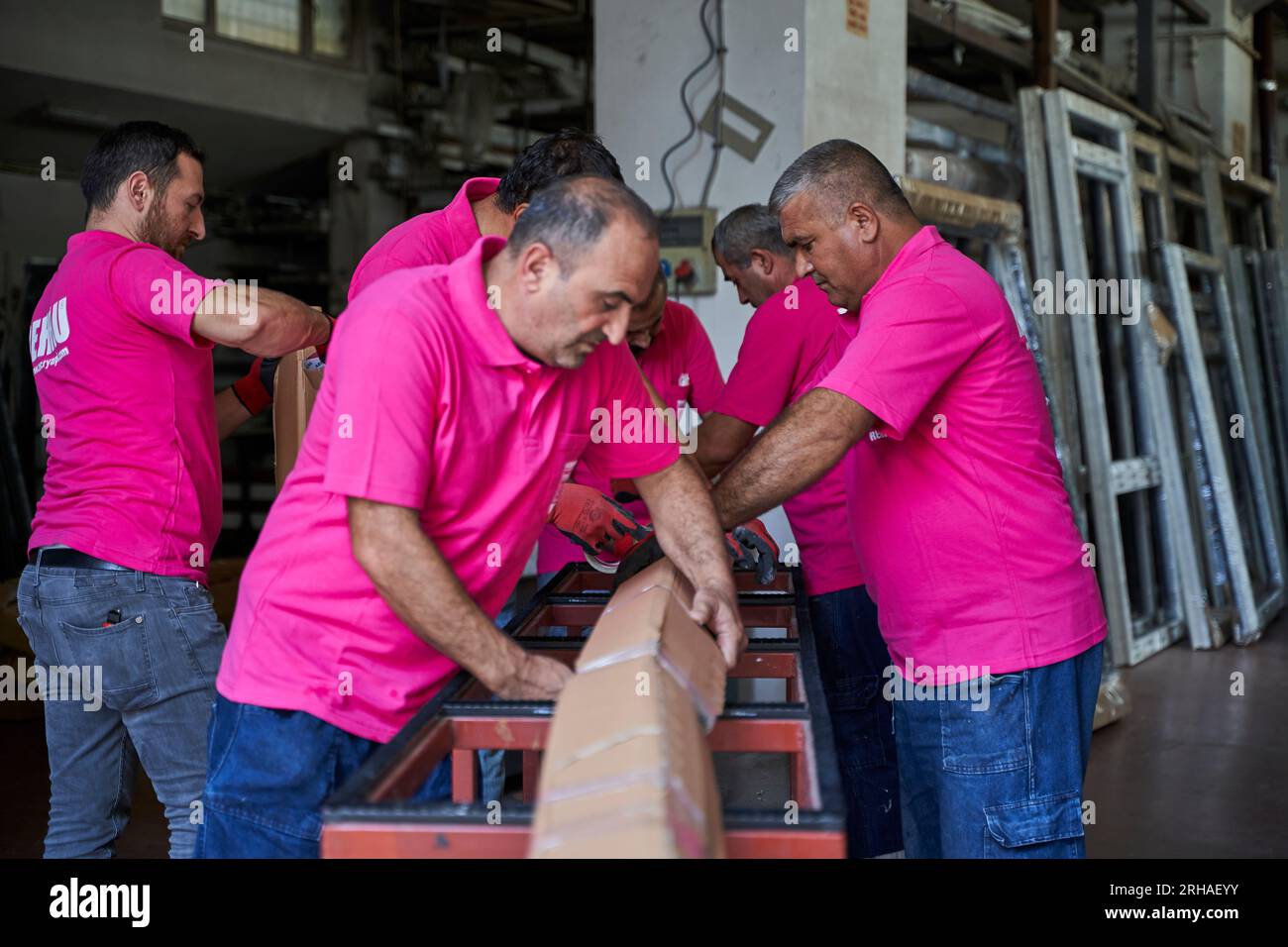 Workers packing cardboard box in warehouse for shipment. an operator ...