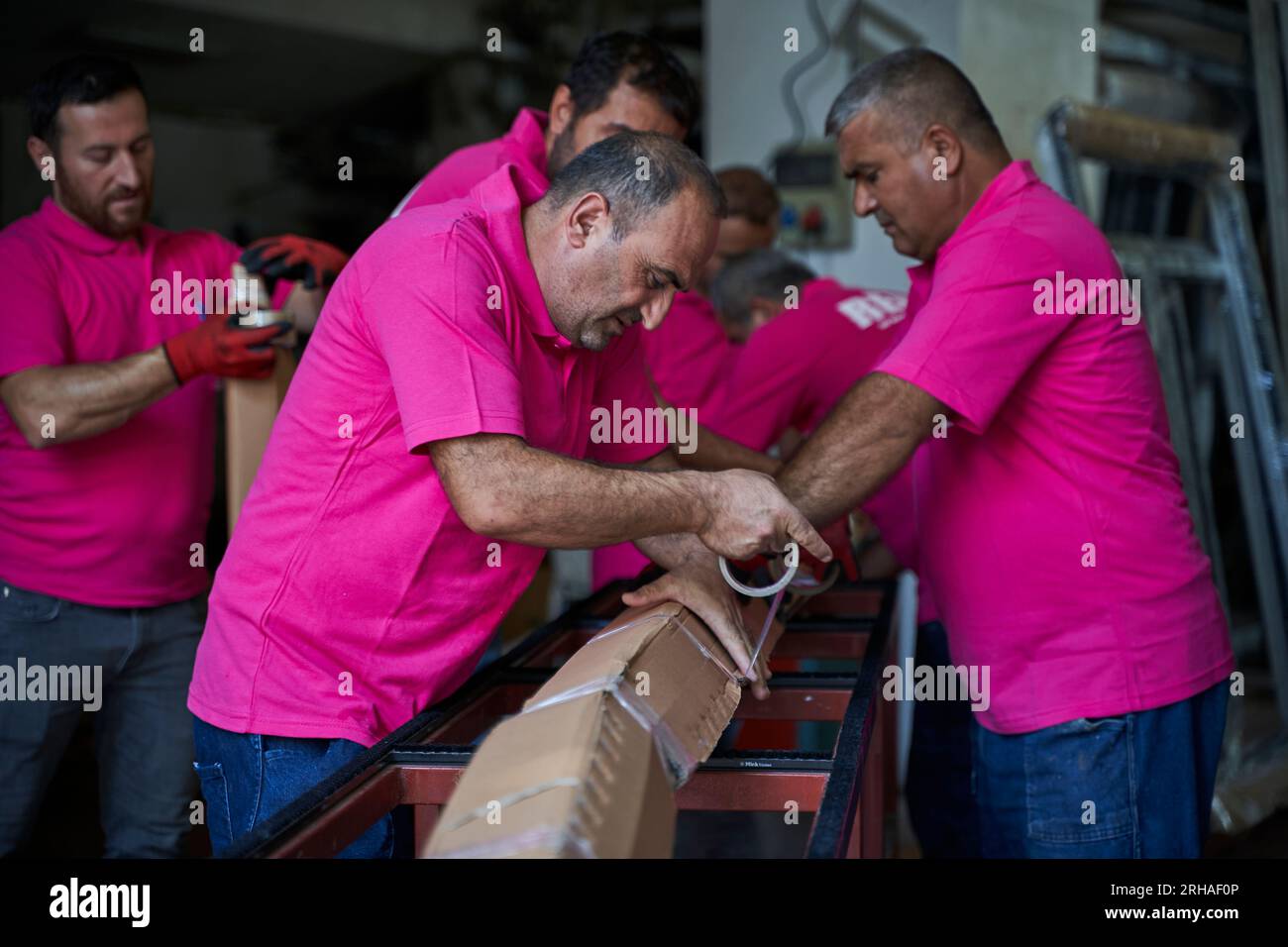 Workers packing cardboard box in warehouse for shipment. an operator ...
