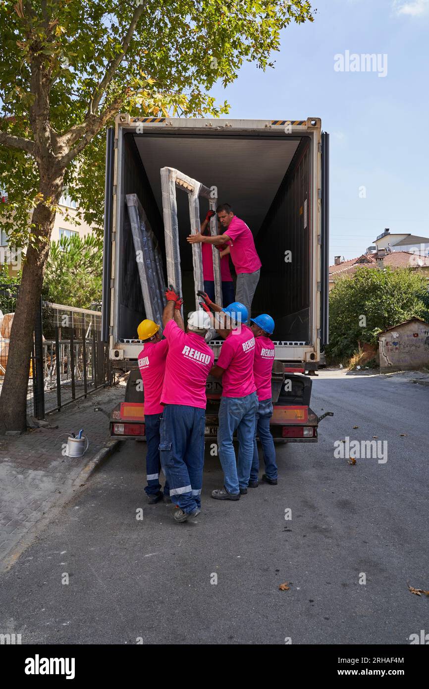 Workers packaging glass sheets in warehouse. worker shipping glass ...