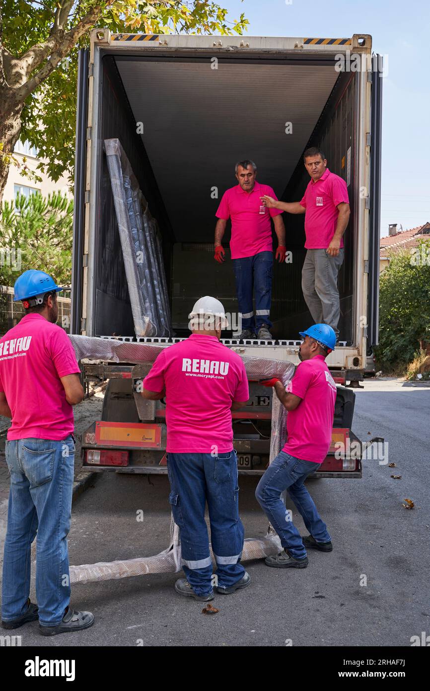 Workers packaging glass sheets in warehouse. worker shipping glass ...