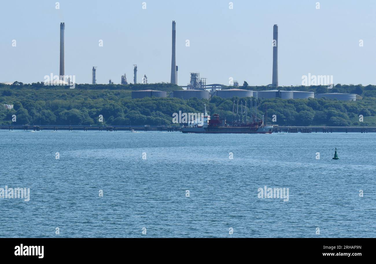 The 'City of Cardiff' dredger passes in front of the Pembroke Refinery ...