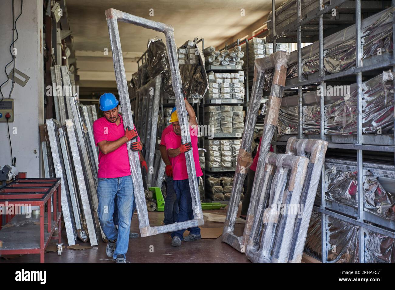 Workers packaging glass sheets in warehouse. worker shipping glass ...