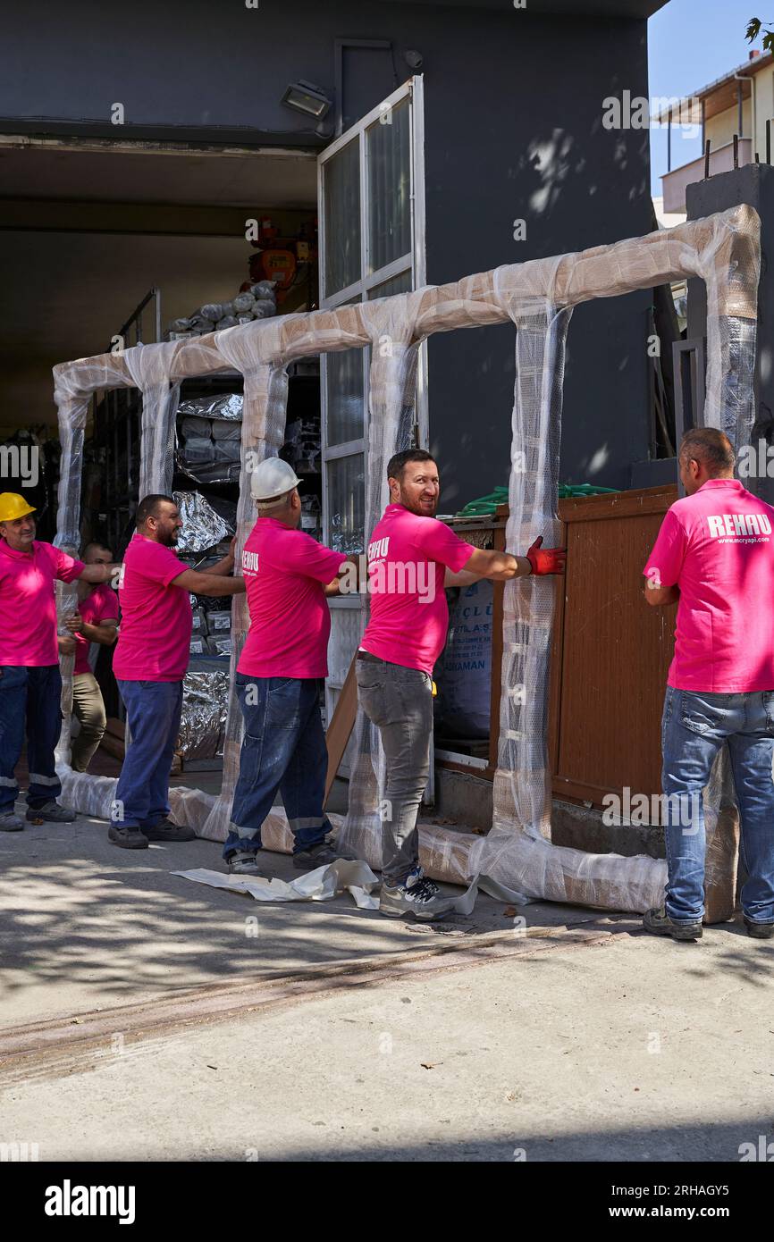 Workers packaging glass sheets in warehouse. worker shipping glass ...