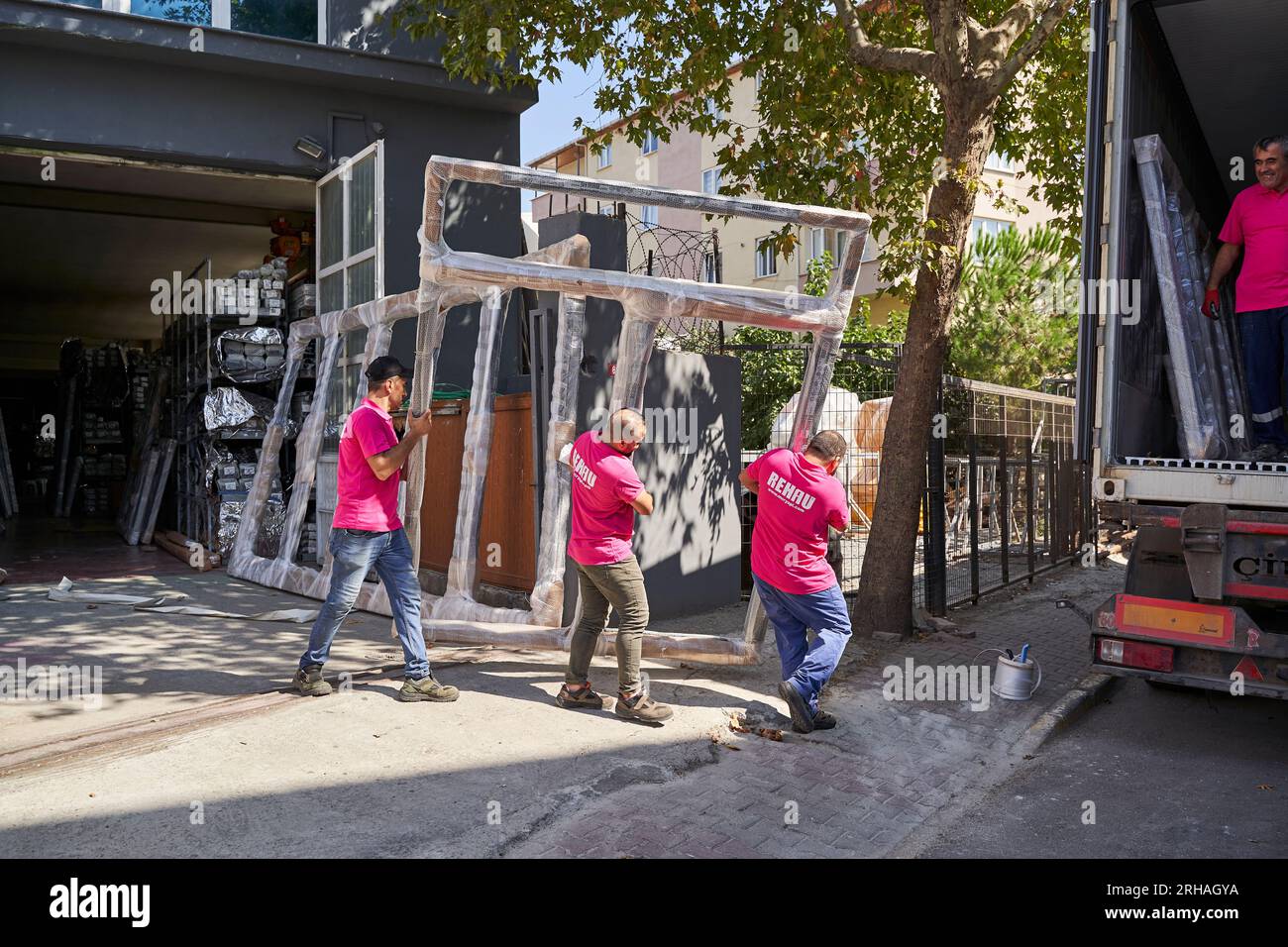 Workers packaging glass sheets in warehouse. worker shipping glass ...