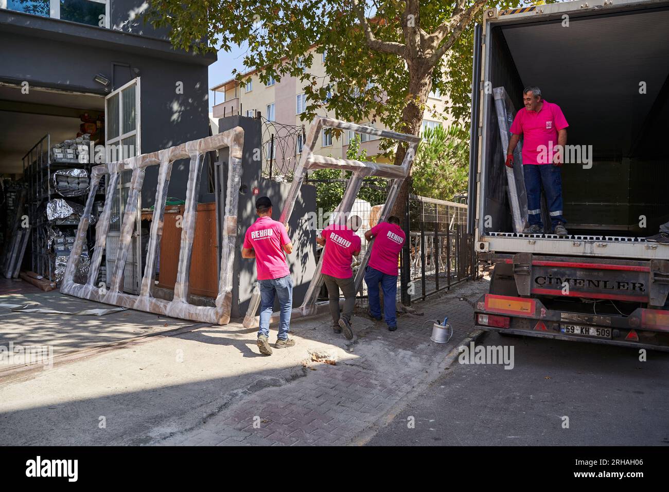 Workers packaging glass sheets in warehouse. worker shipping glass ...