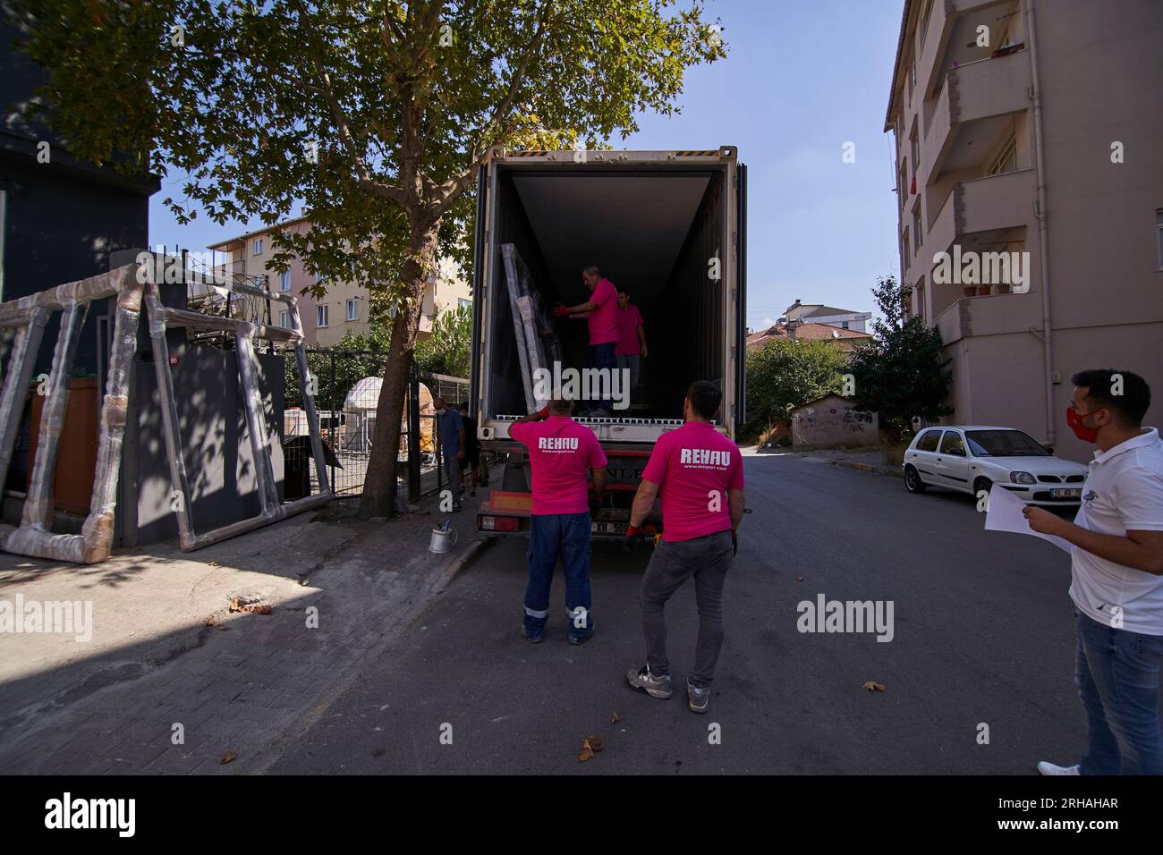 Workers packaging glass sheets in warehouse. worker shipping glass ...