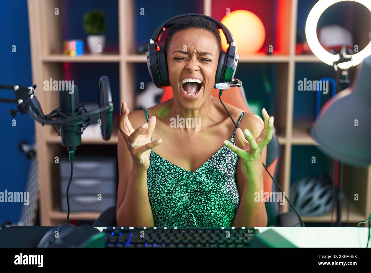 African american woman playing video games crazy and mad shouting and ...