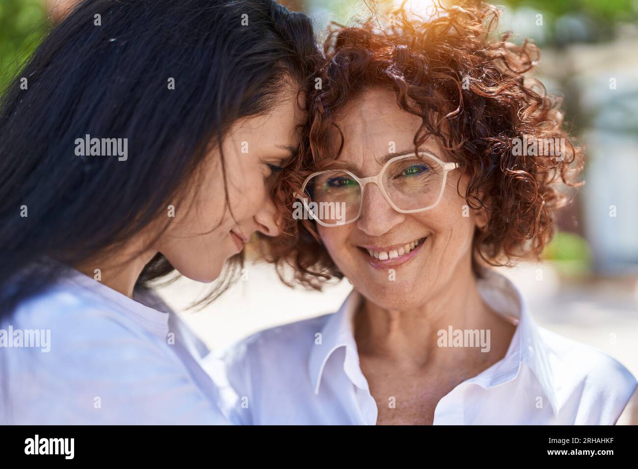 Two women mother and daughter standing together at park Stock Photo - Alamy