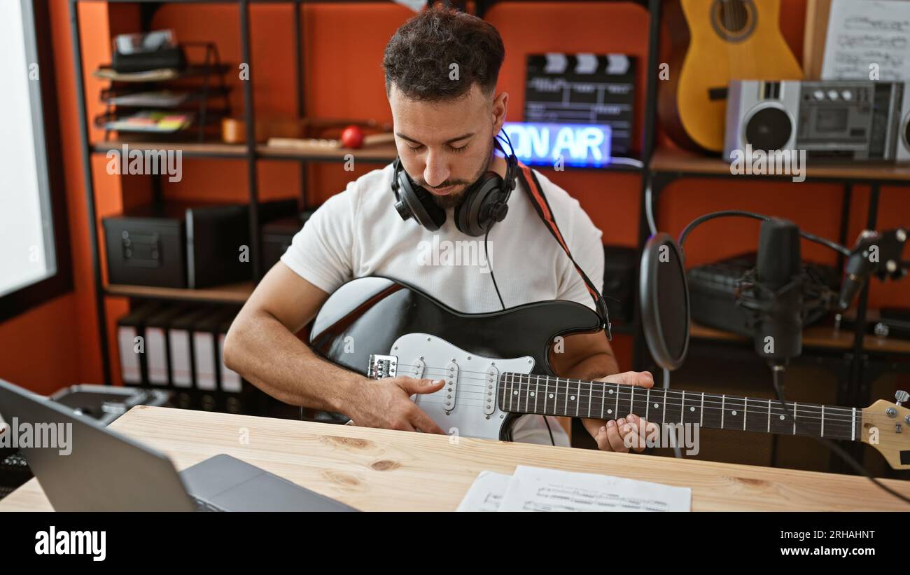 Young arab man musician playing electrical guitar at music studio Stock ...