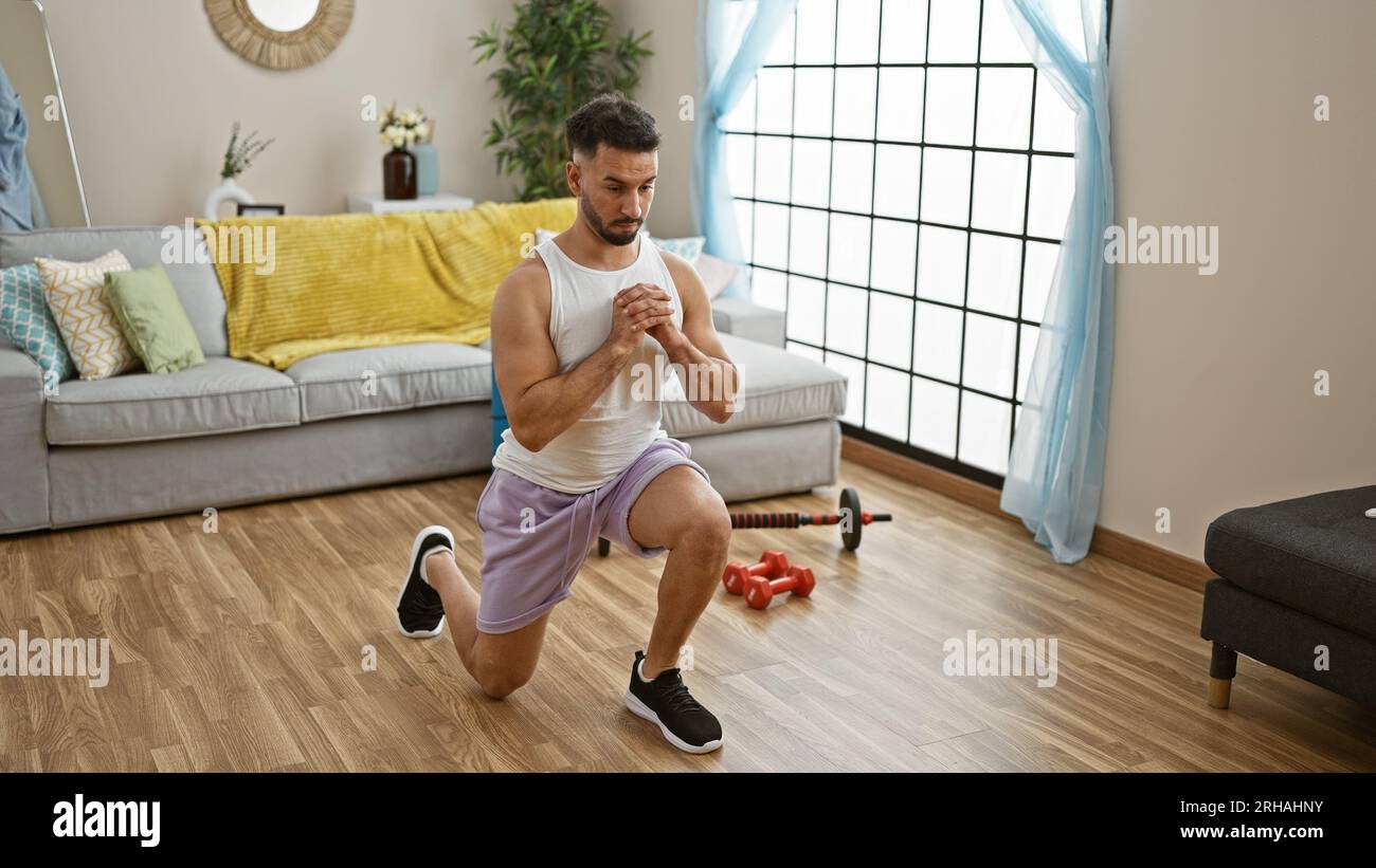 Young arab man training legs exercise at home Stock Photo - Alamy