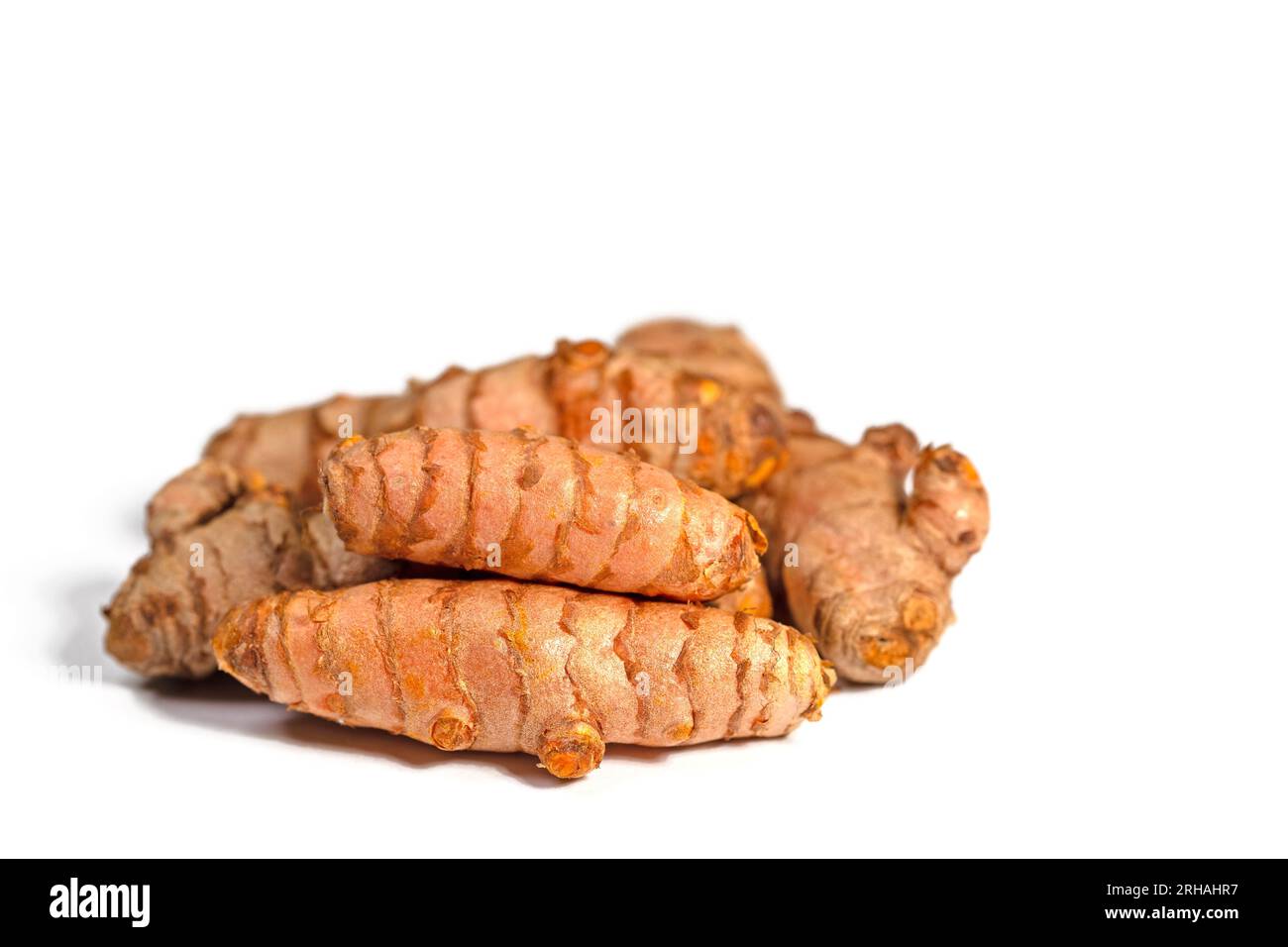 Turmeric root against white background Stock Photo - Alamy