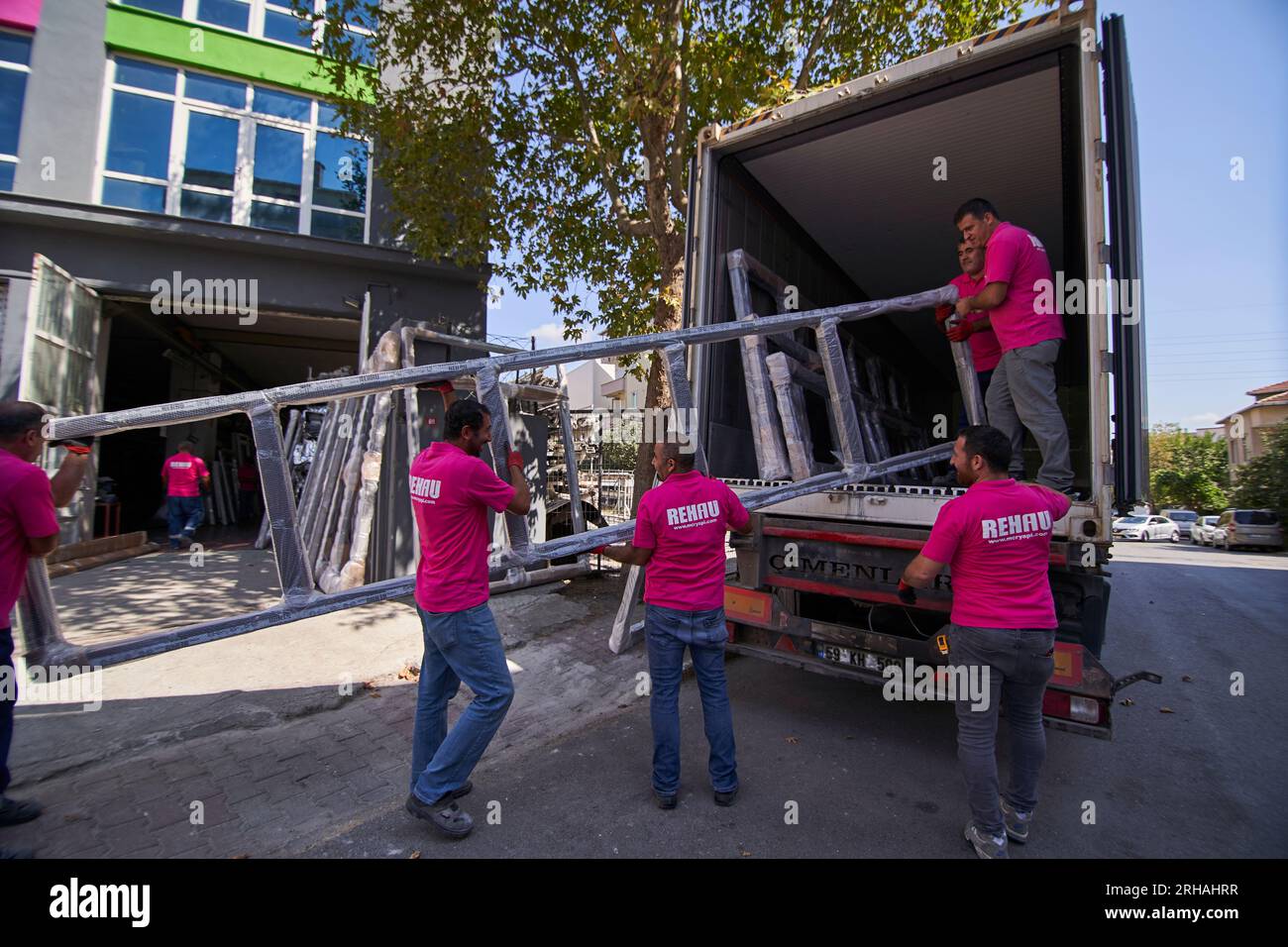 Workers packaging glass sheets in warehouse. worker shipping glass ...