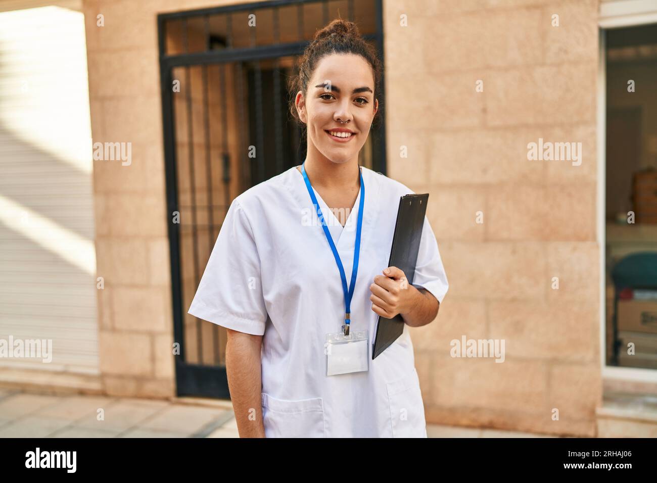 Young beautiful hispanic woman physiotherapist smiling confident ...