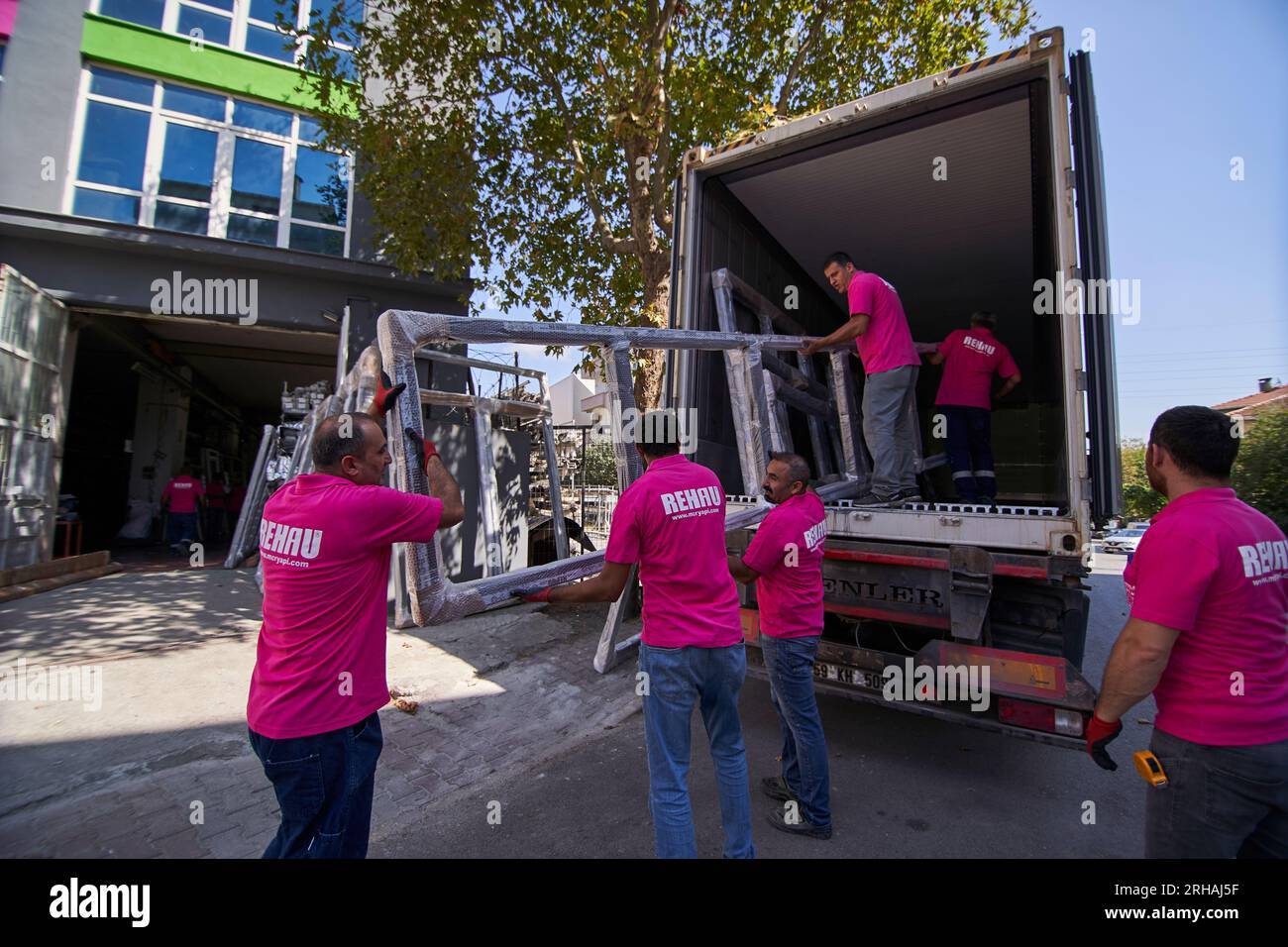 Workers packaging glass sheets in warehouse. worker shipping glass ...