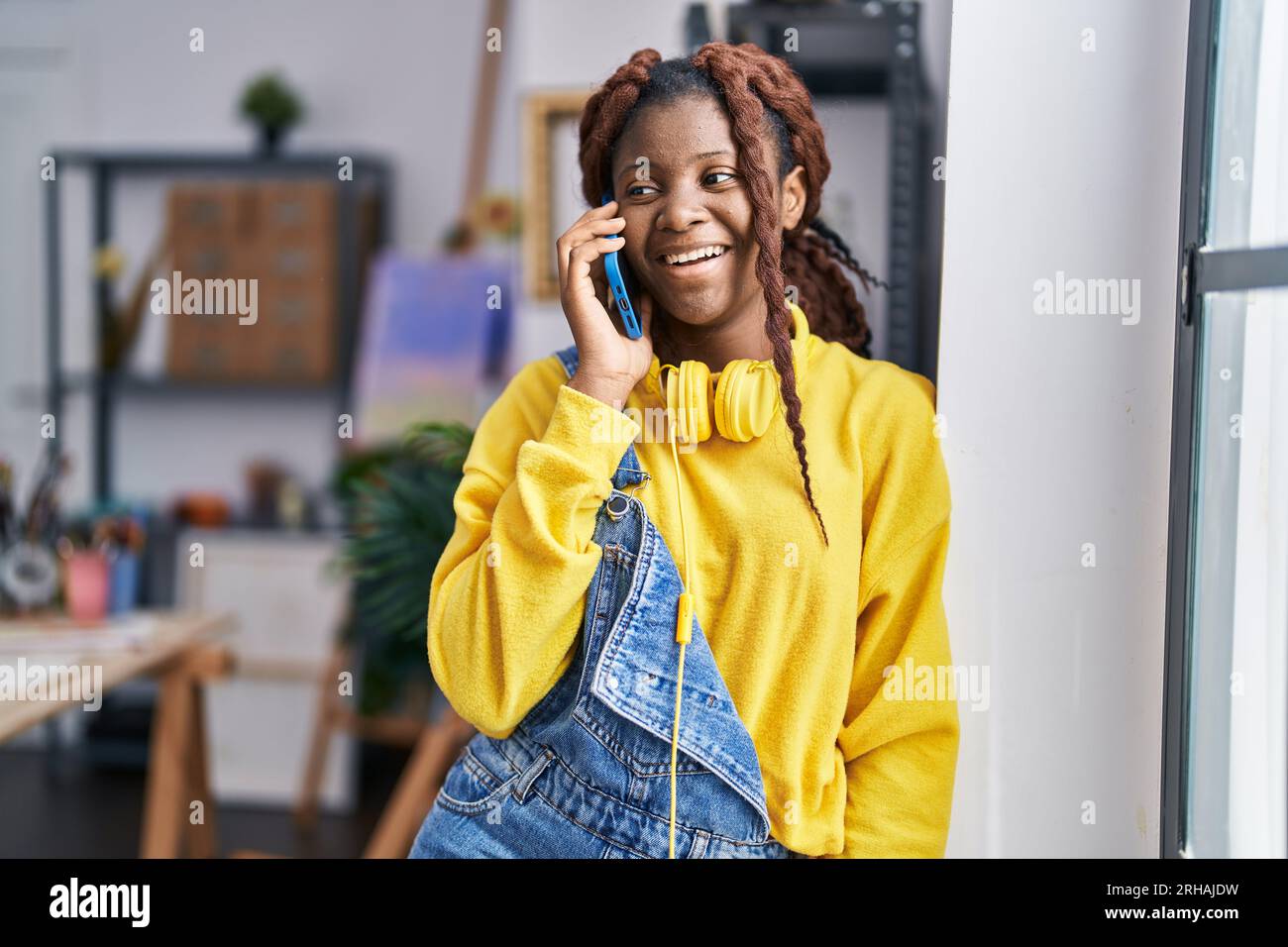 African american woman artist talking on smartphone standing at art ...
