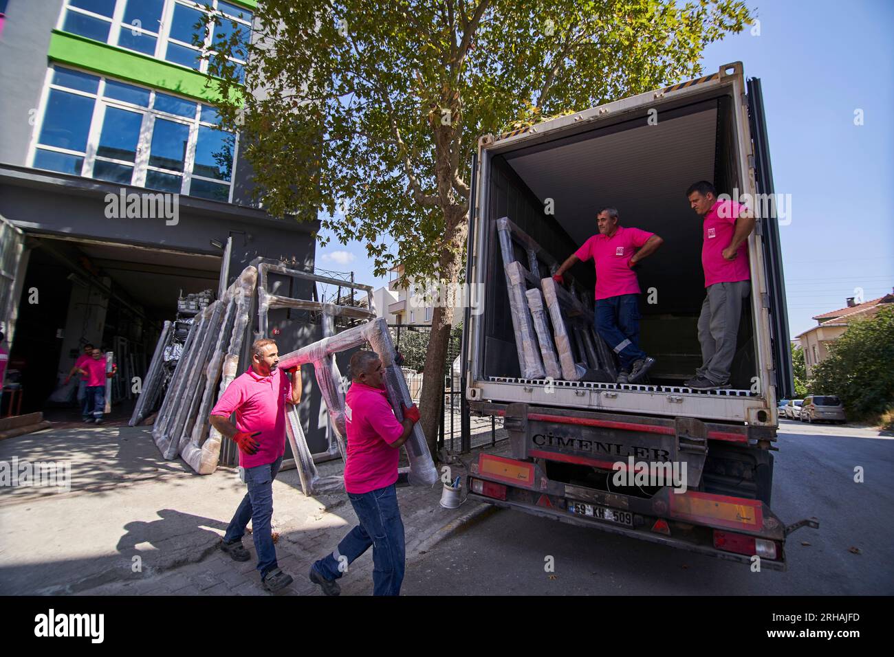 Workers packaging glass sheets in warehouse. worker shipping glass ...