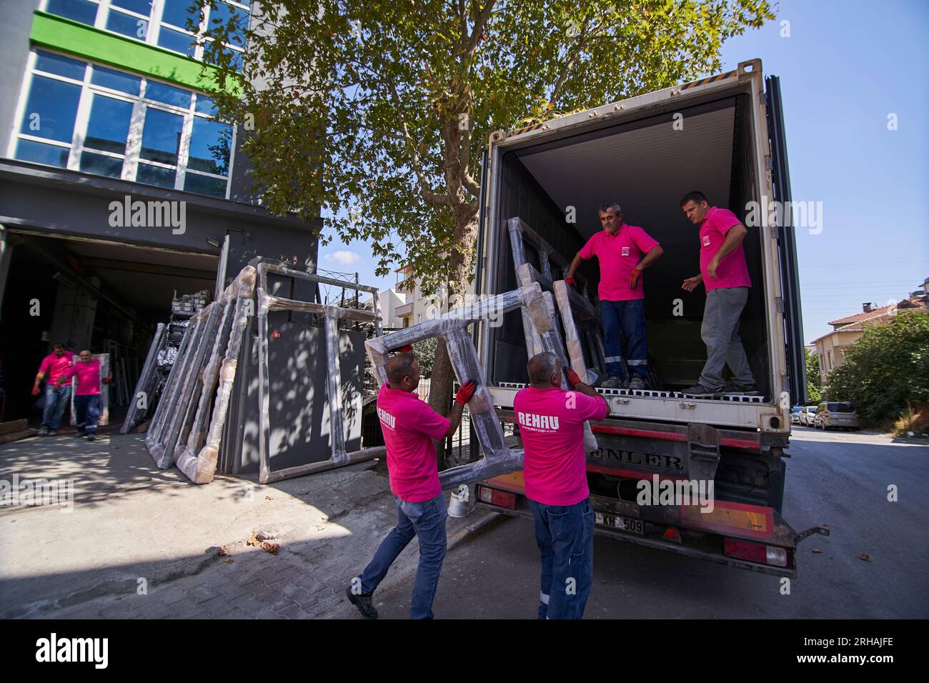 Workers packaging glass sheets in warehouse. worker shipping glass ...