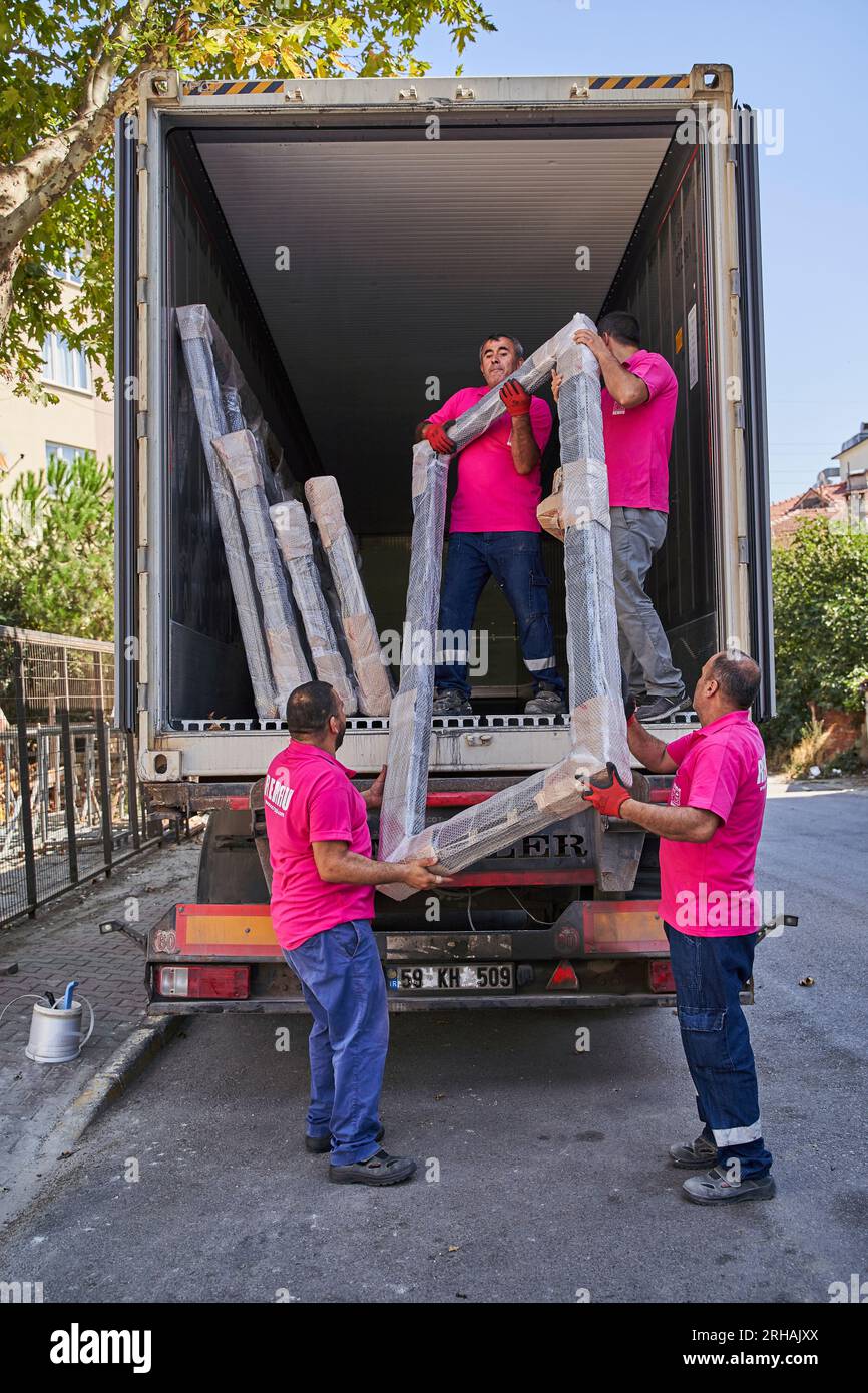 Workers packaging glass sheets in warehouse. worker shipping glass ...
