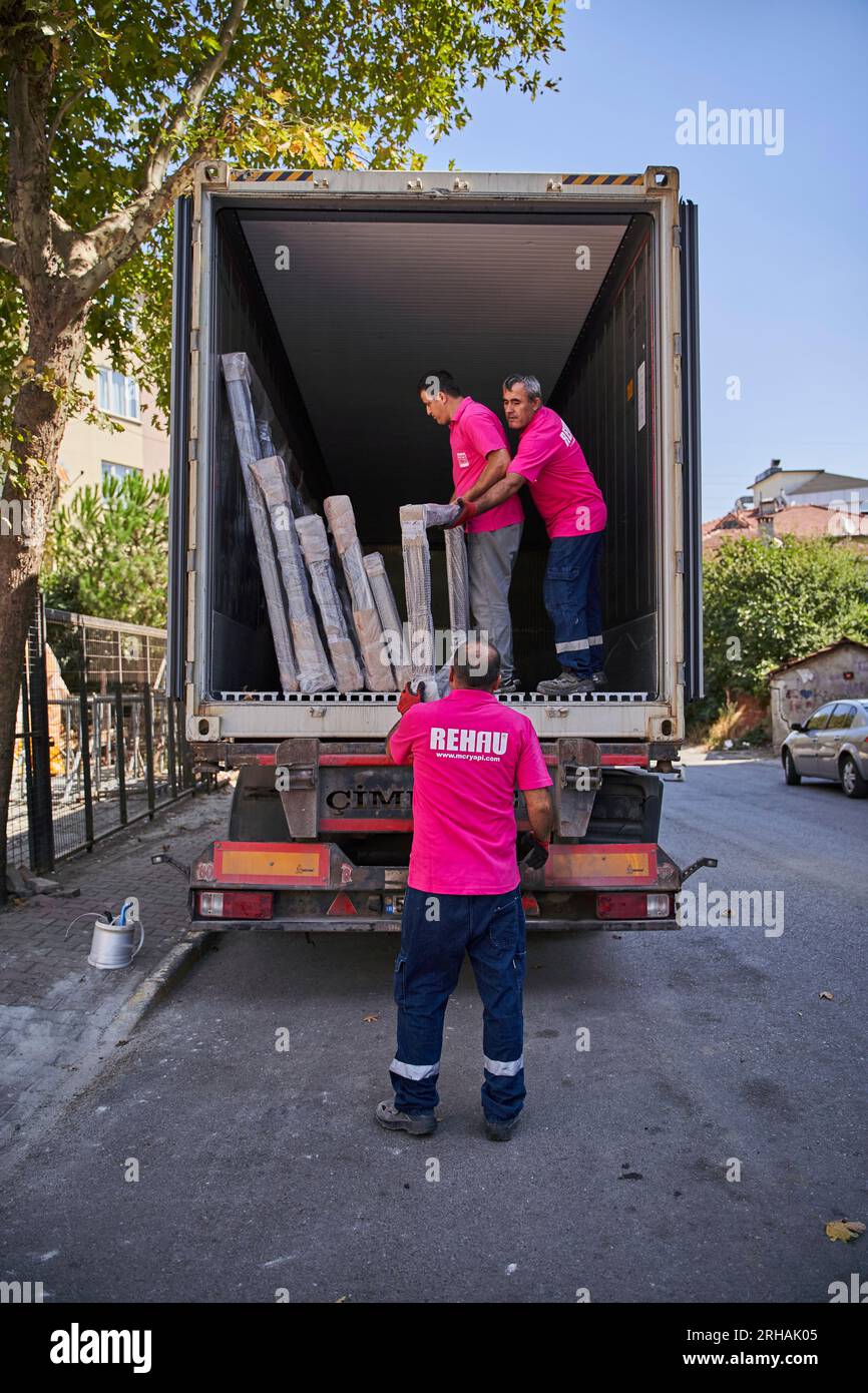 Workers packaging glass sheets in warehouse. worker shipping glass ...