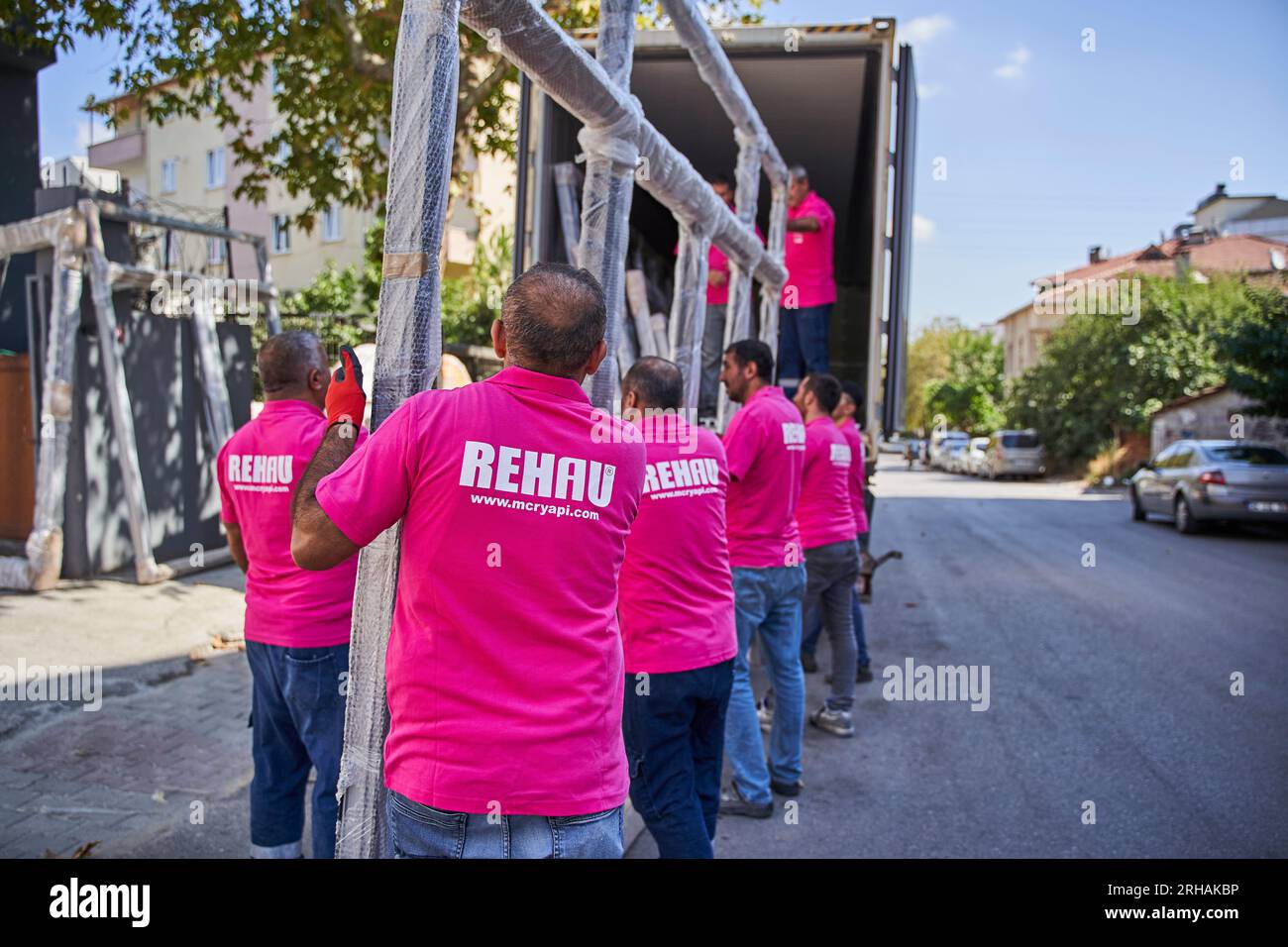 Workers packaging glass sheets in warehouse. worker shipping glass ...