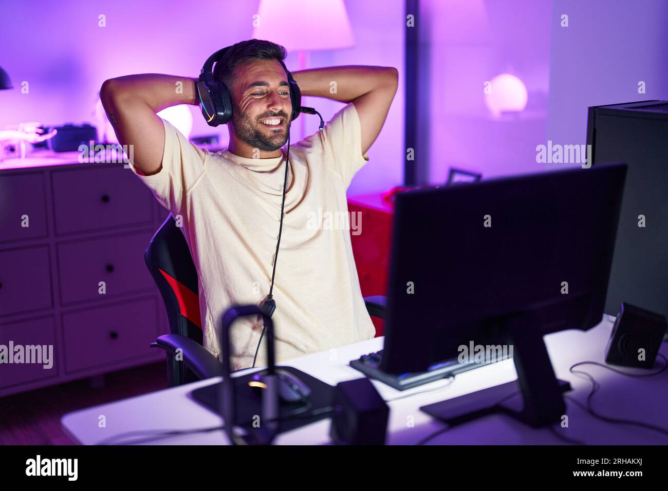 Young hispanic man streamer smiling confident relaxed with hands on ...