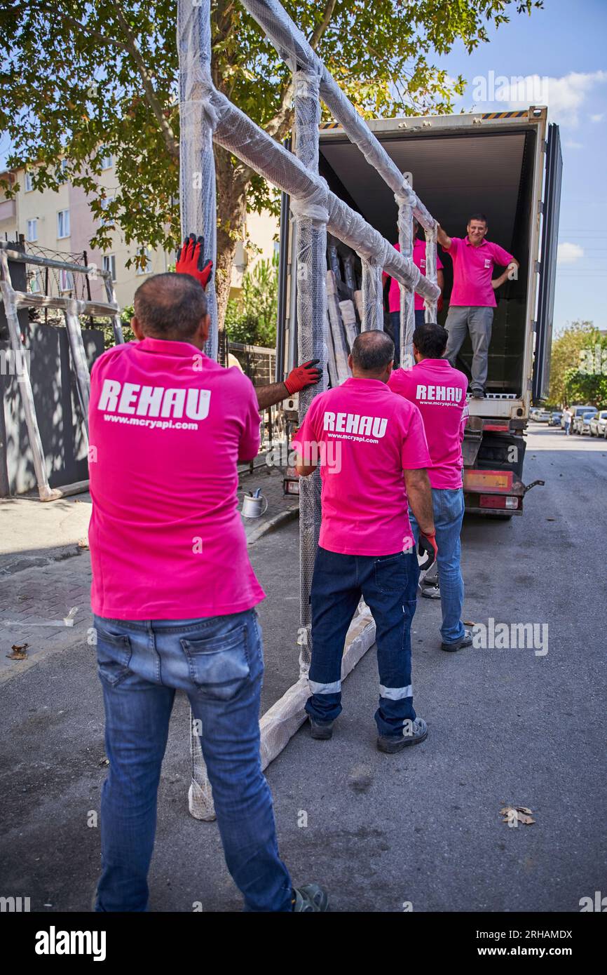 Workers packaging glass sheets in warehouse. worker shipping glass ...