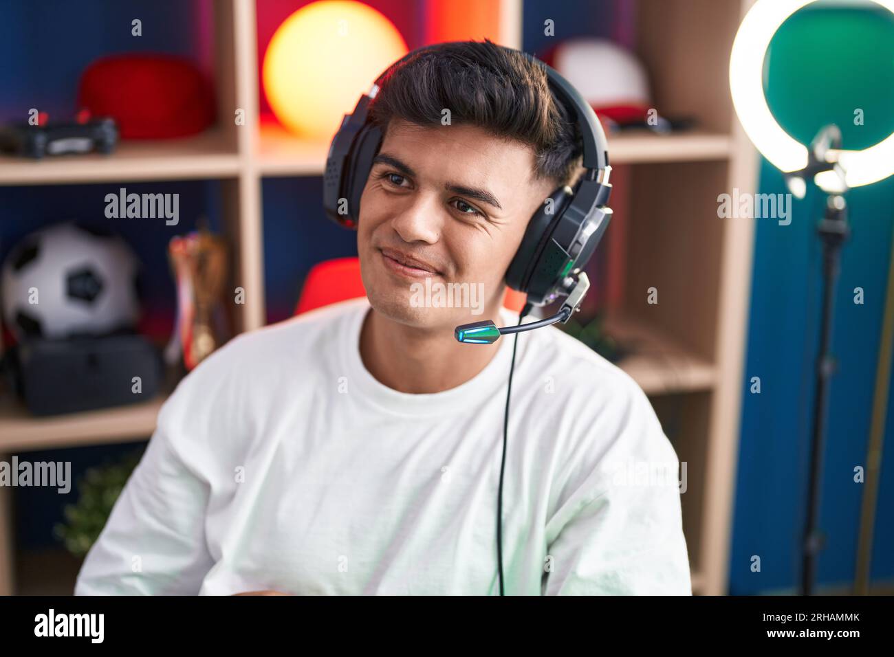 Young hispanic man streamer smiling confident sitting on table at ...