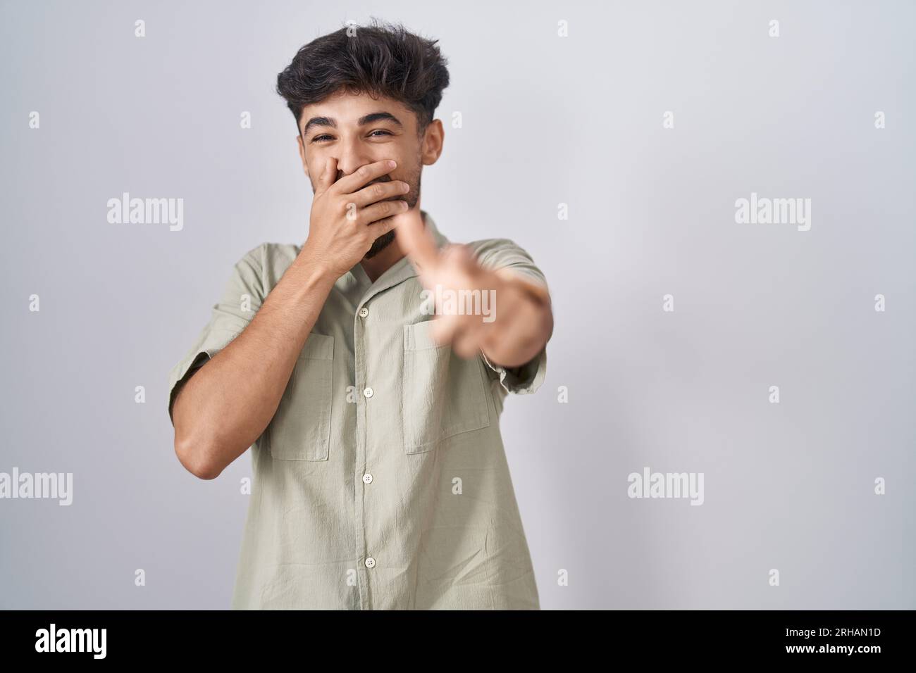Arab man with beard standing over white background laughing at you ...
