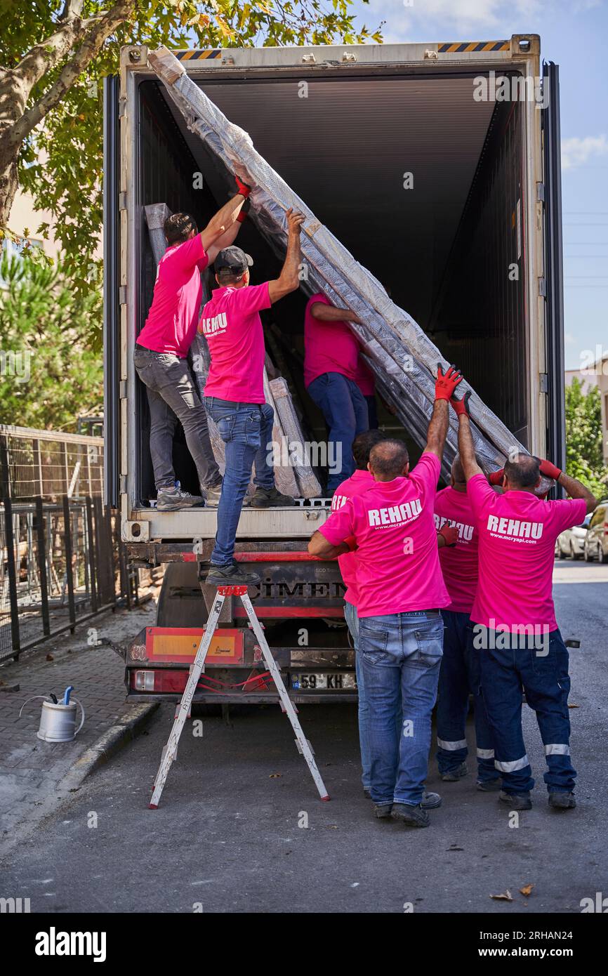 Workers packaging glass sheets in warehouse. worker shipping glass ...