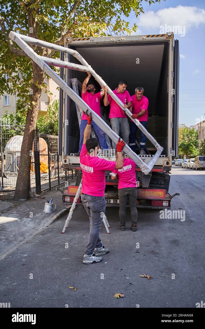 Workers packaging glass sheets in warehouse. worker shipping glass ...