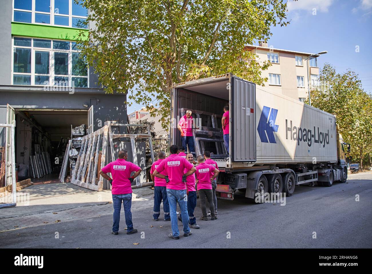 Workers packaging glass sheets in warehouse. worker shipping glass ...