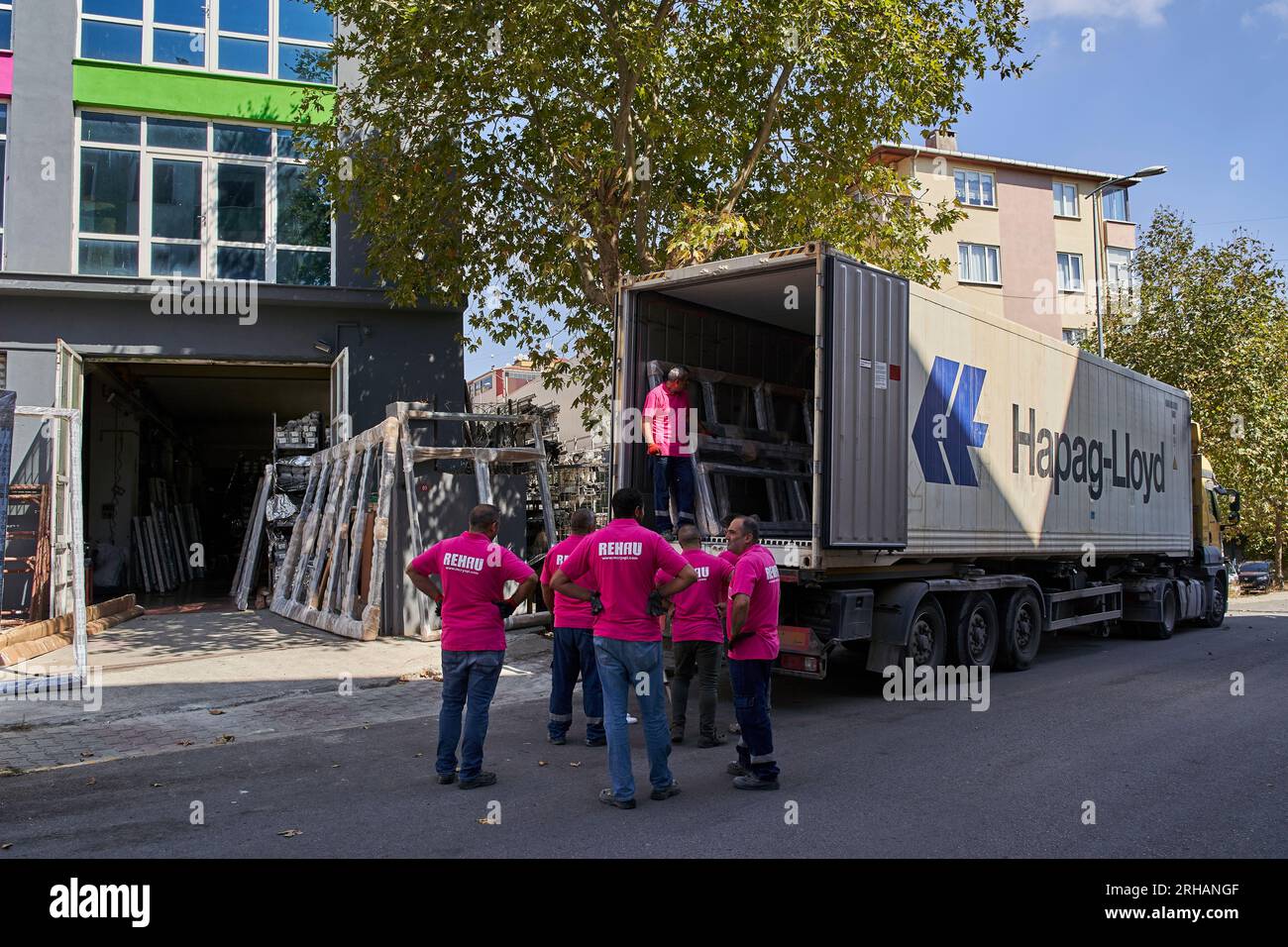 Workers packaging glass sheets in warehouse. worker shipping glass ...