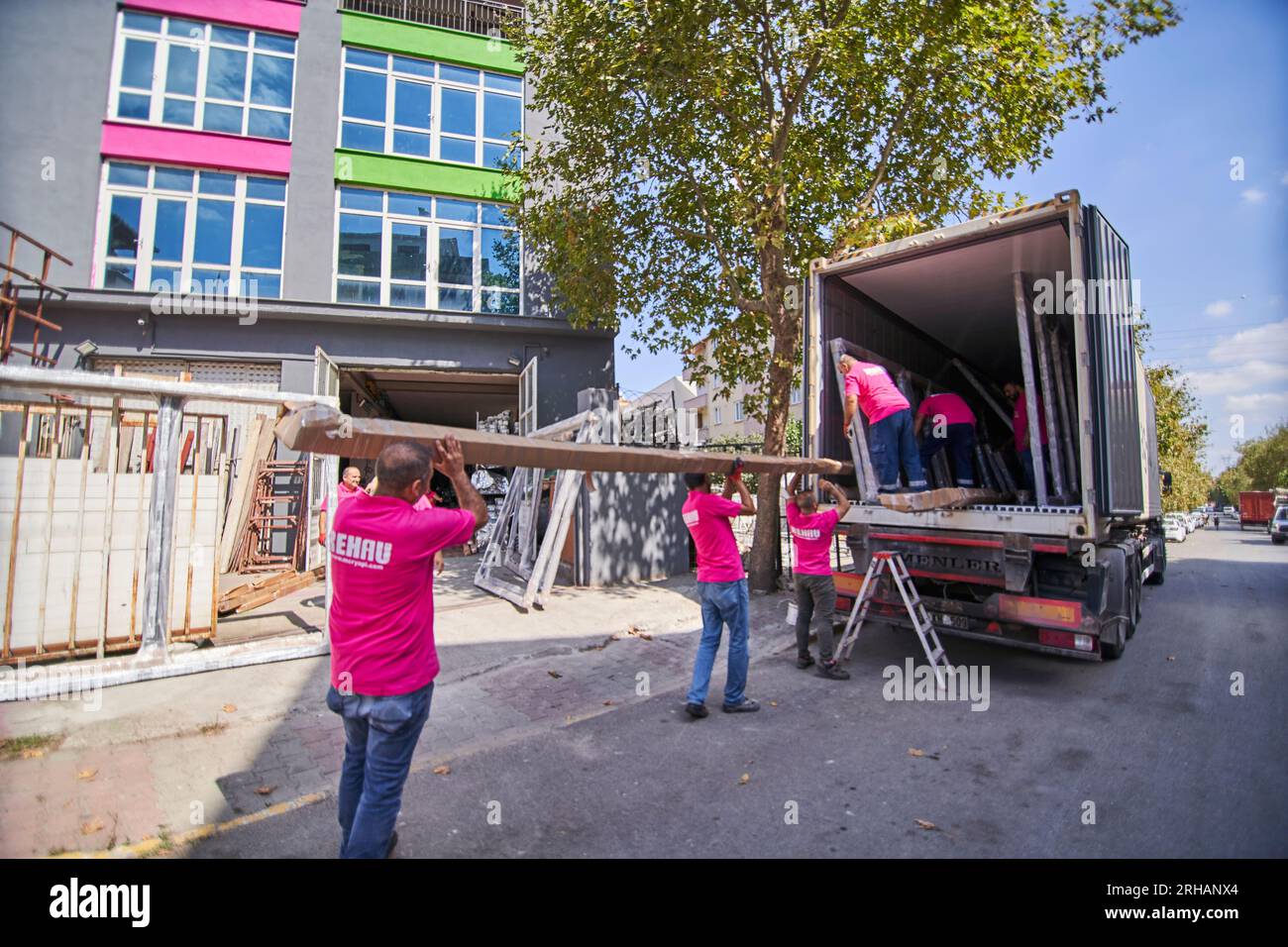 Workers packaging glass sheets in warehouse. worker shipping glass ...