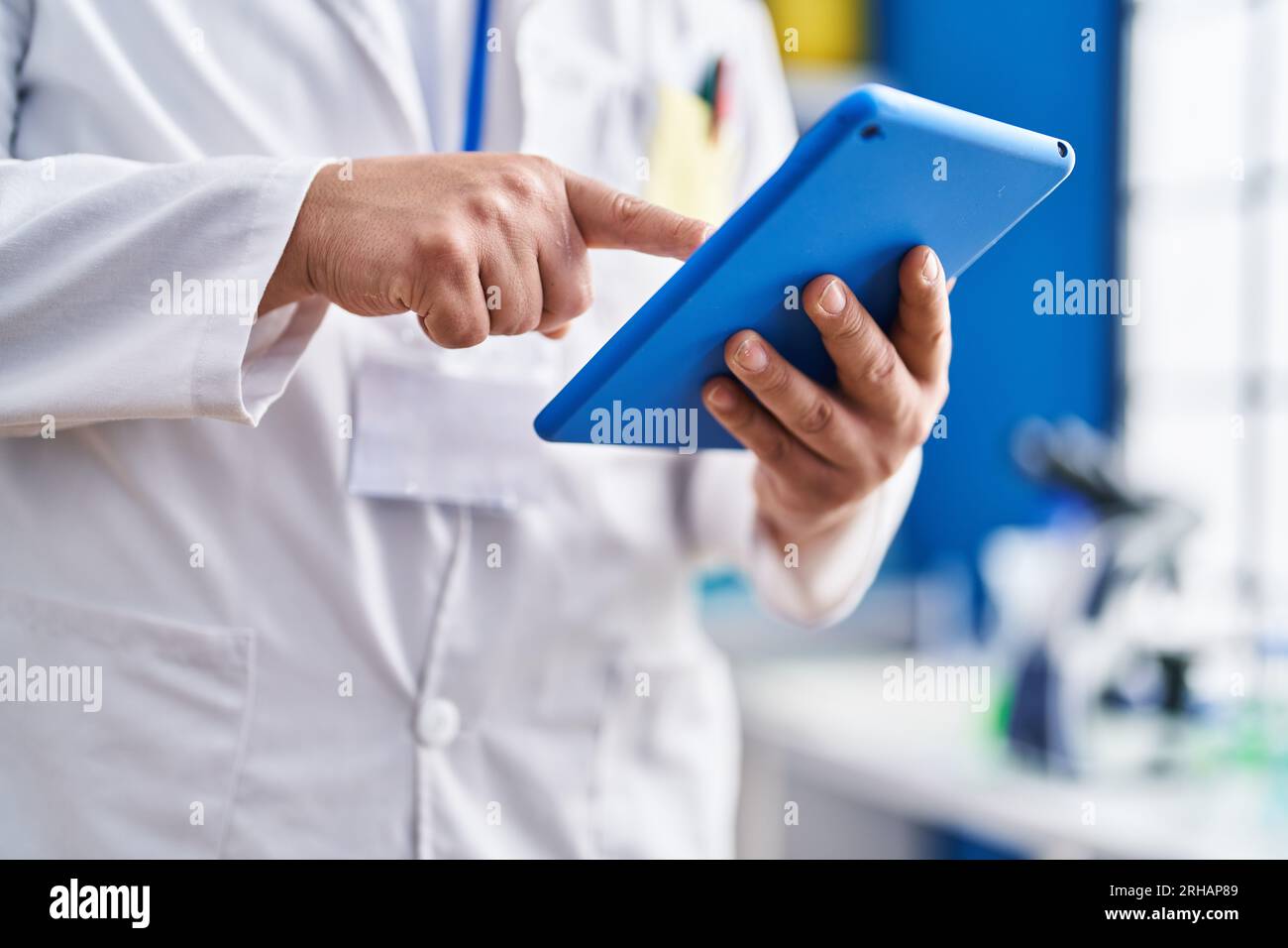 Young latin man scientist using touchpad at laboratory Stock Photo - Alamy