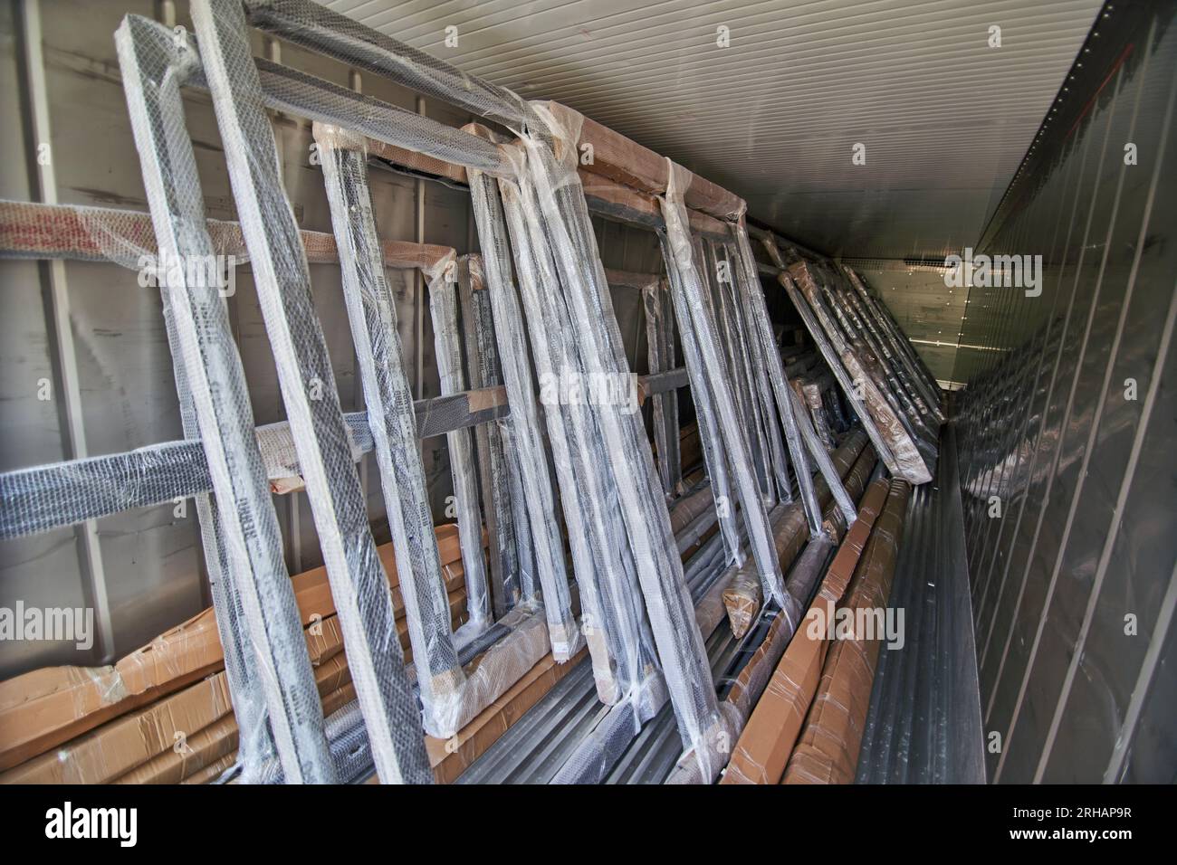 Workers packaging glass sheets in warehouse. worker shipping glass ...