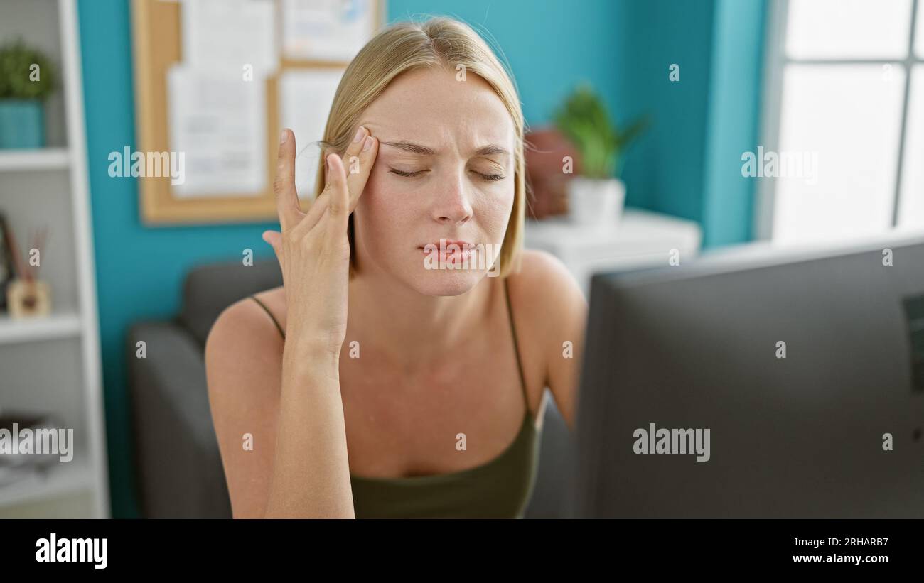 Young blonde woman business worker stressed using computer at the ...