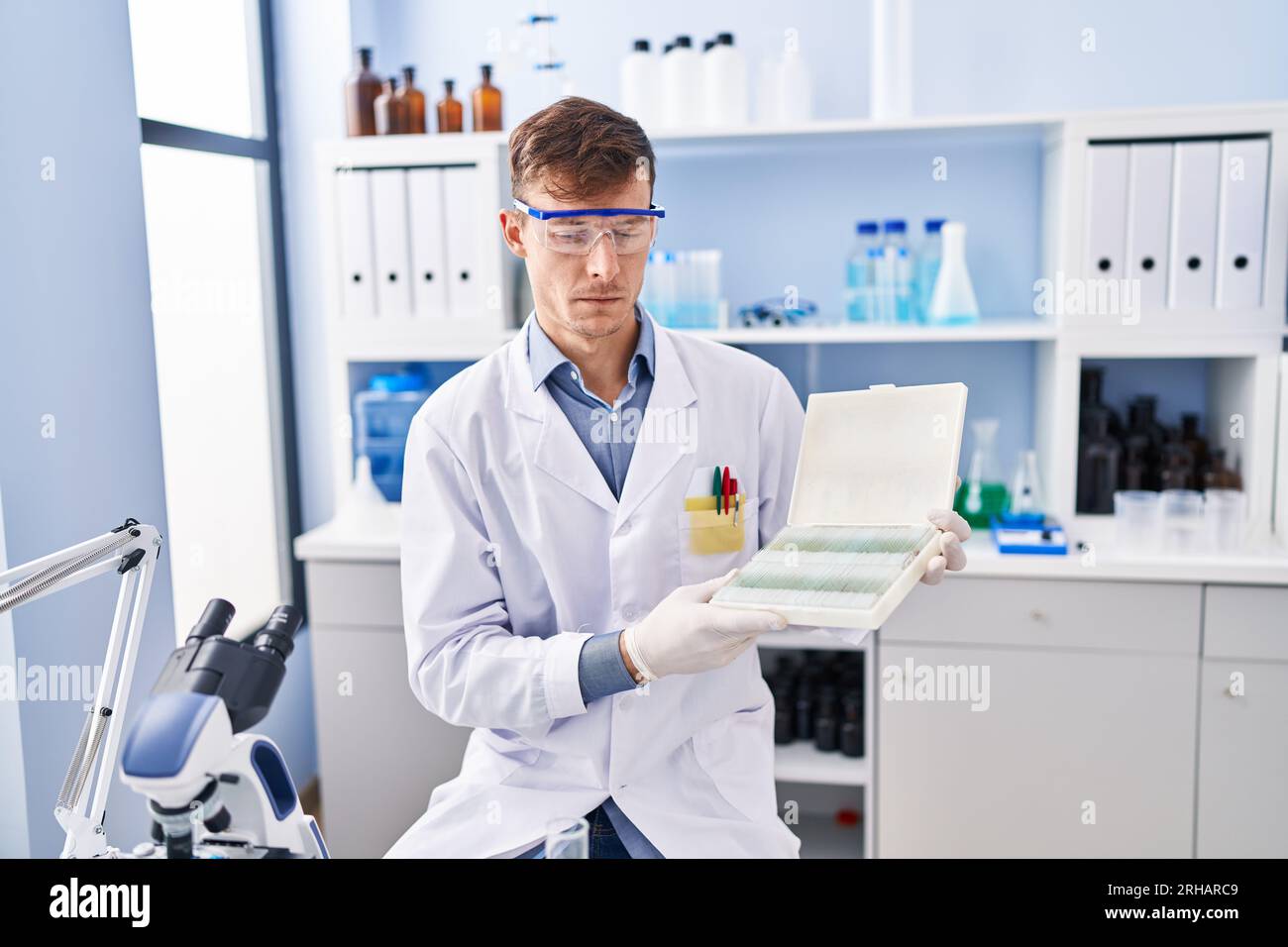 Caucasian man working at scientist laboratory depressed and worry for ...