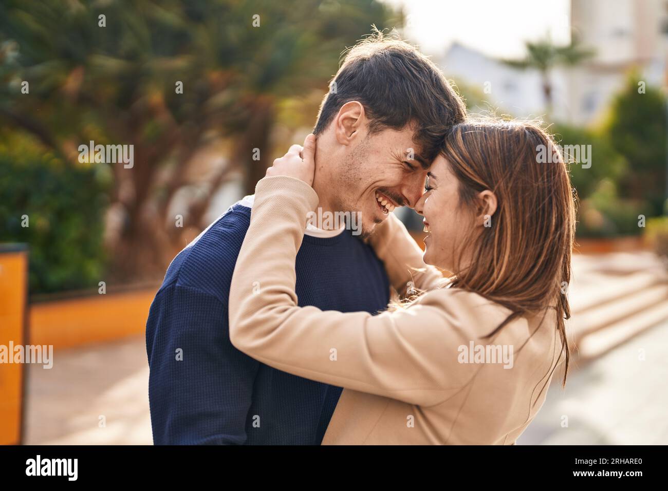 Mand and woman couple hugging each other at park Stock Photo - Alamy