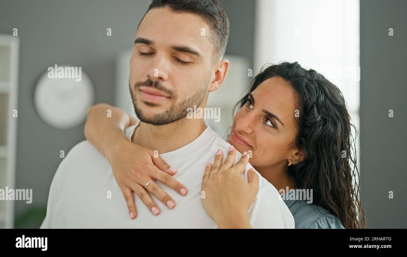 Man and woman couple consoling boyfriend standing at home Stock Photo ...