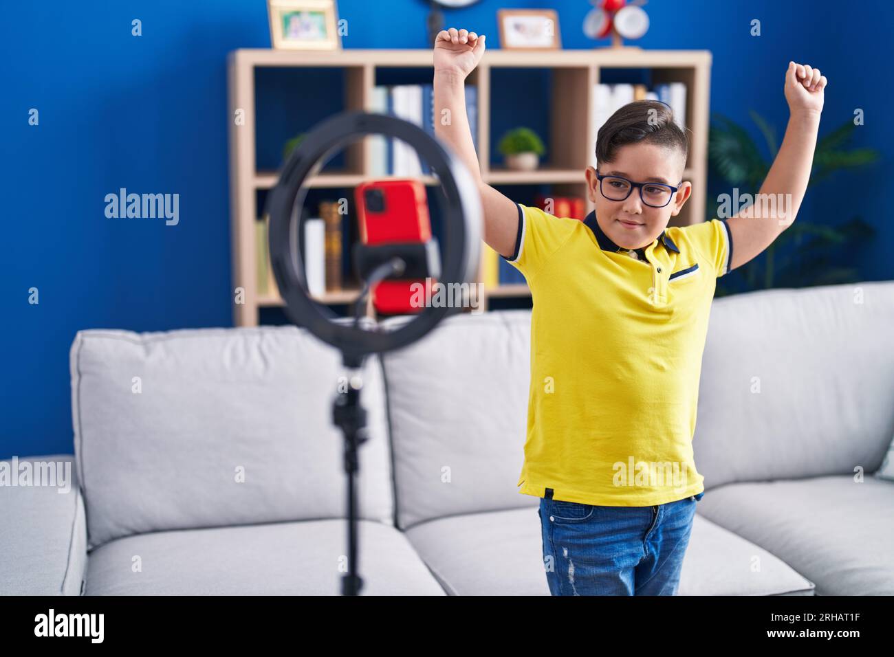 Adorable hispanic boy recording video dancing at home Stock Photo - Alamy