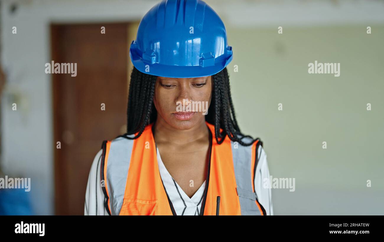 African american woman builder standing with relaxed expression at ...
